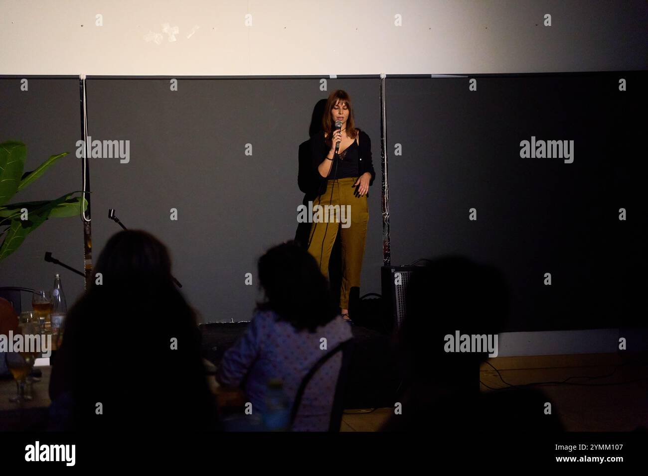 Female performer delivering a monologue on stage in an alternative ...