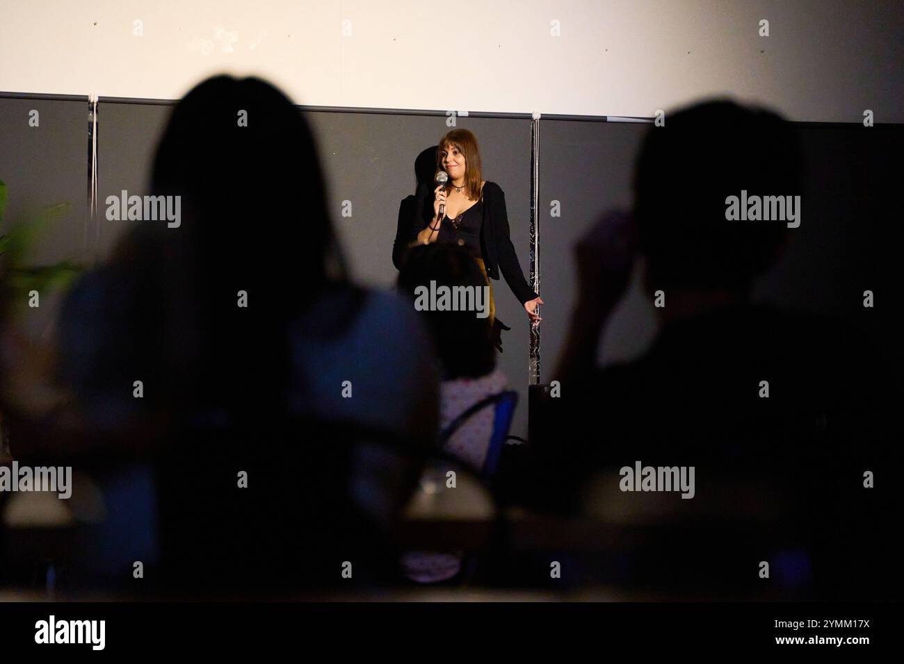 Female performer delivering a monologue on stage in an alternative ...