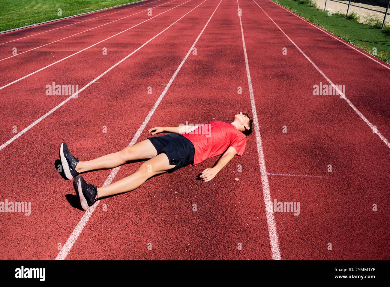 Young man running from sprint start hi-res stock photography and images ...