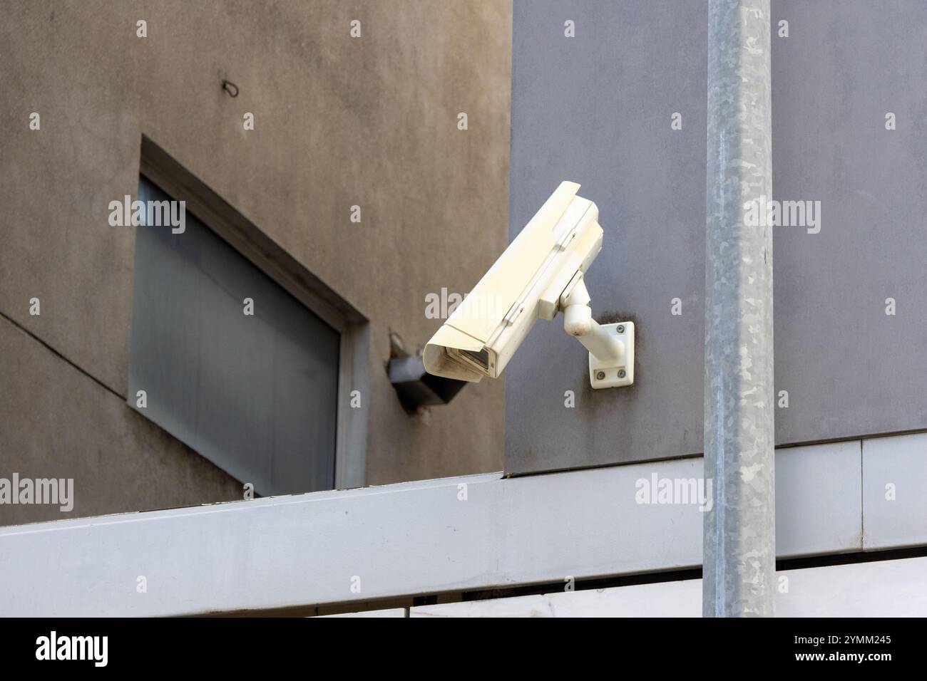 Old security camera mounted on building exterior, providing ...