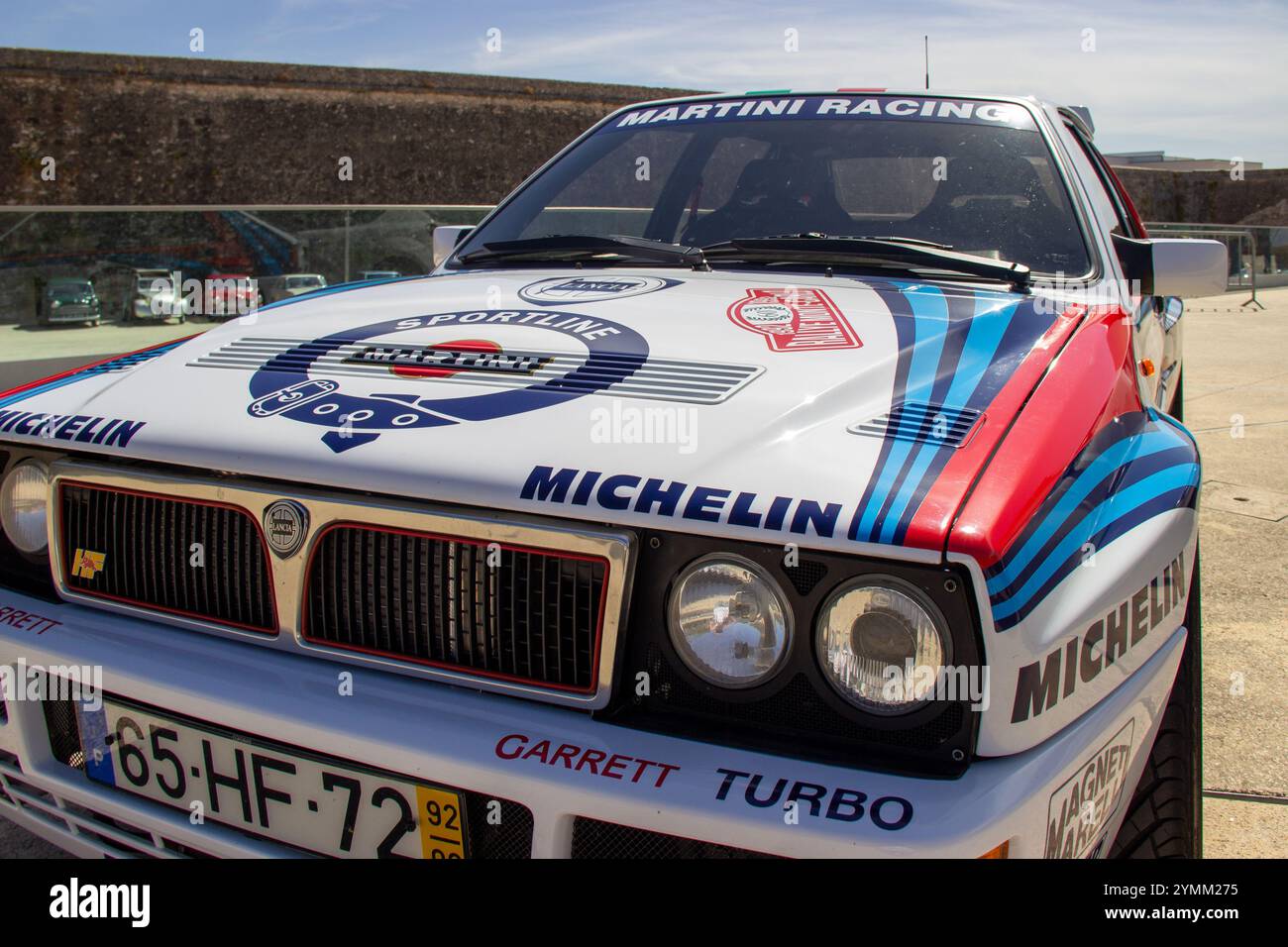 Close up of a white lancia delta integrale evo showcasing martini racing, michelin, and other ...