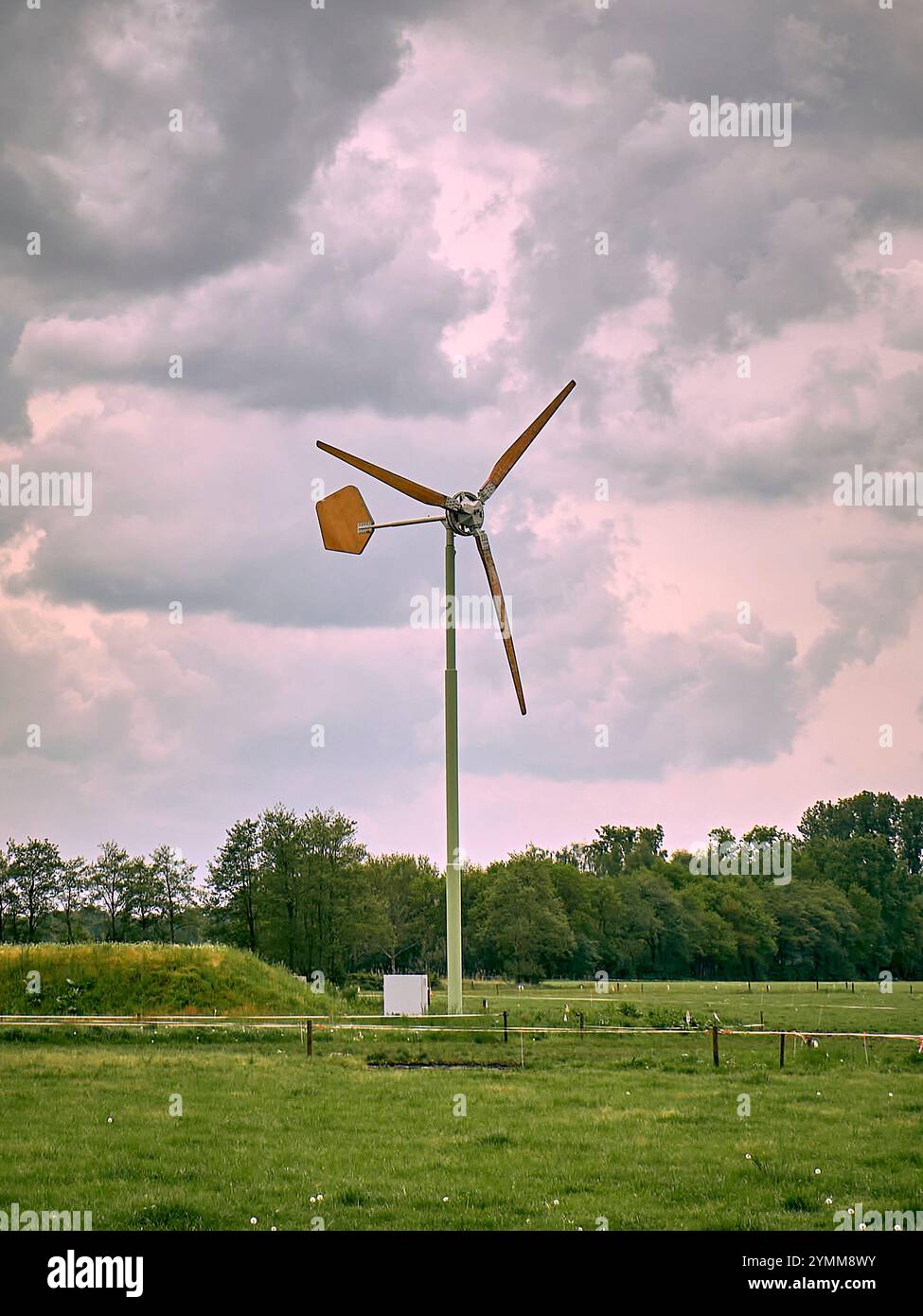 A landscape featuring a small EAZ farm wind turbine, green fields ...