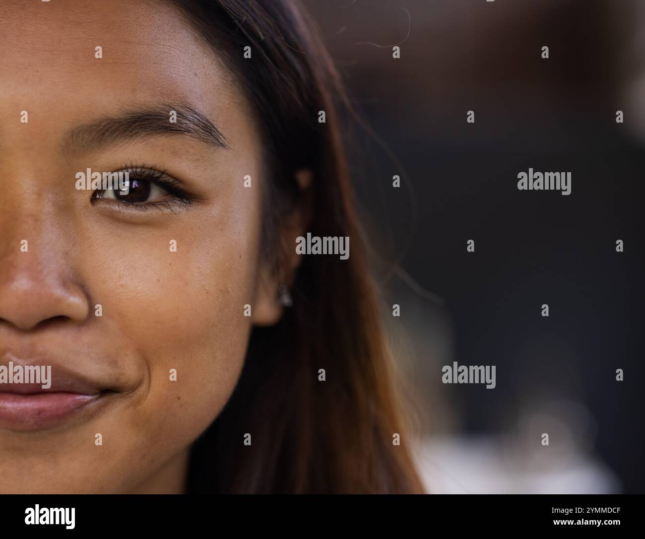 Smiling warmly, asian female teenager in close-up portrait, copy space ...
