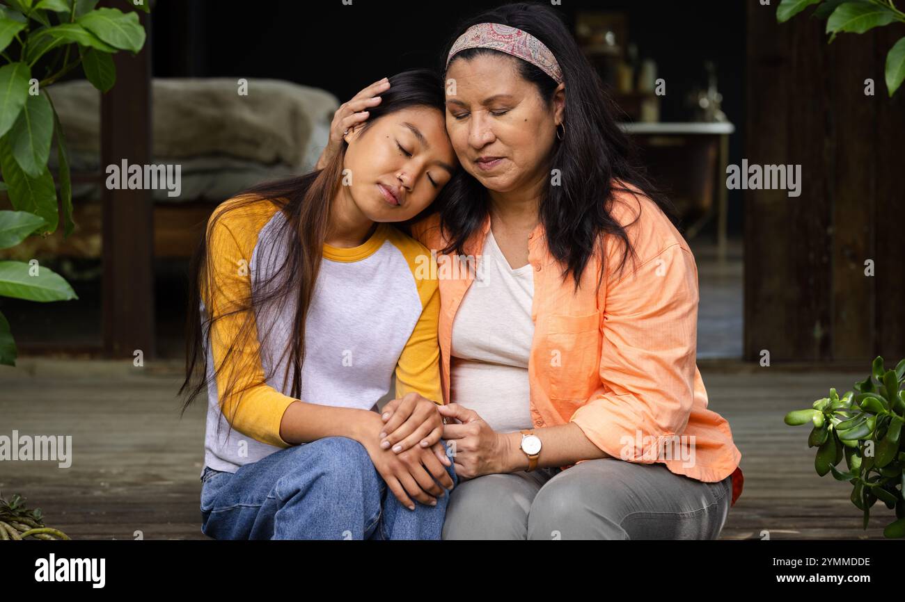 Grandmother and asian female teenager sharing heartfelt moment on porch ...