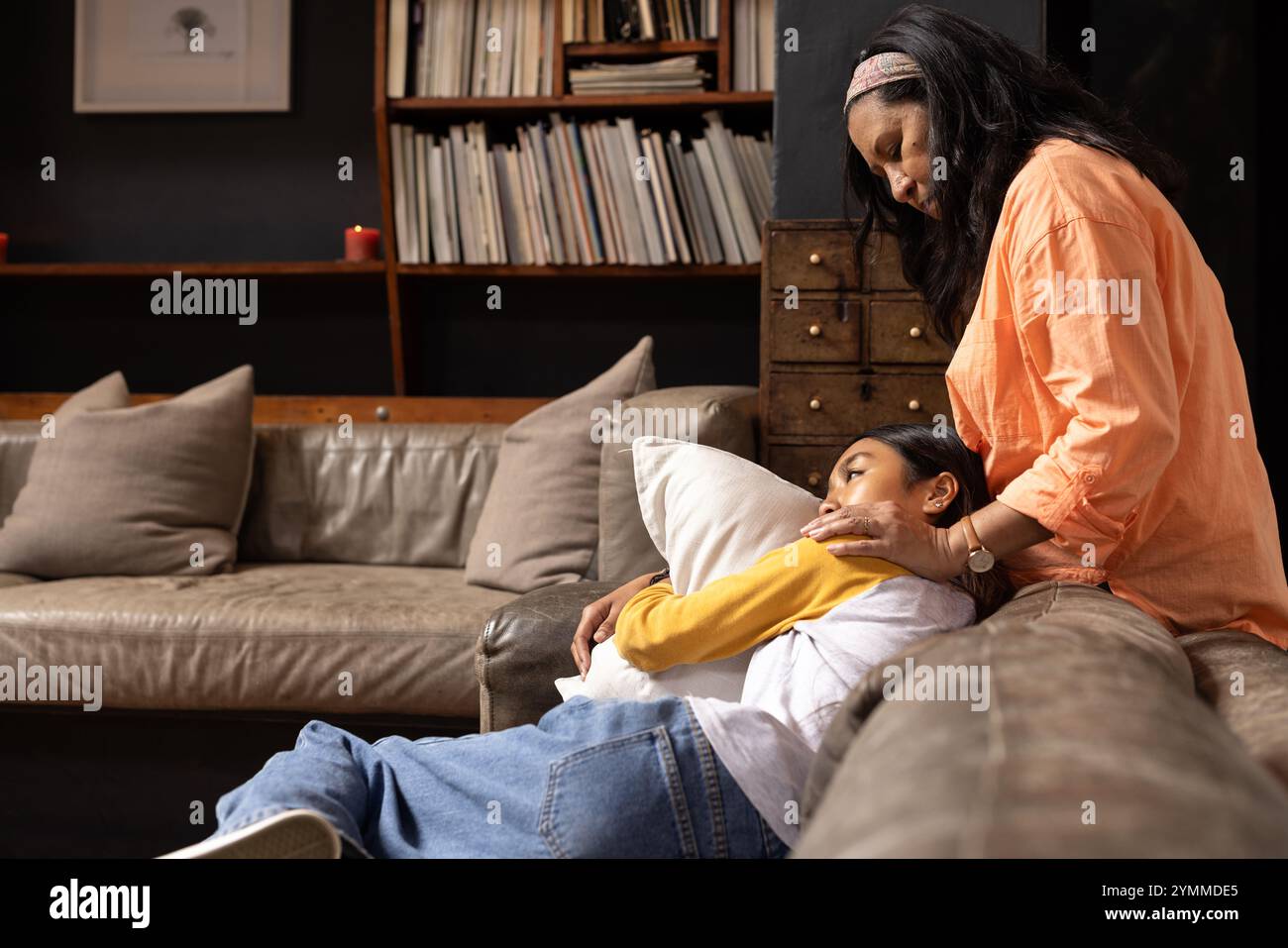 Grandma comforting asian female teenager on couch at home, sharing warm ...