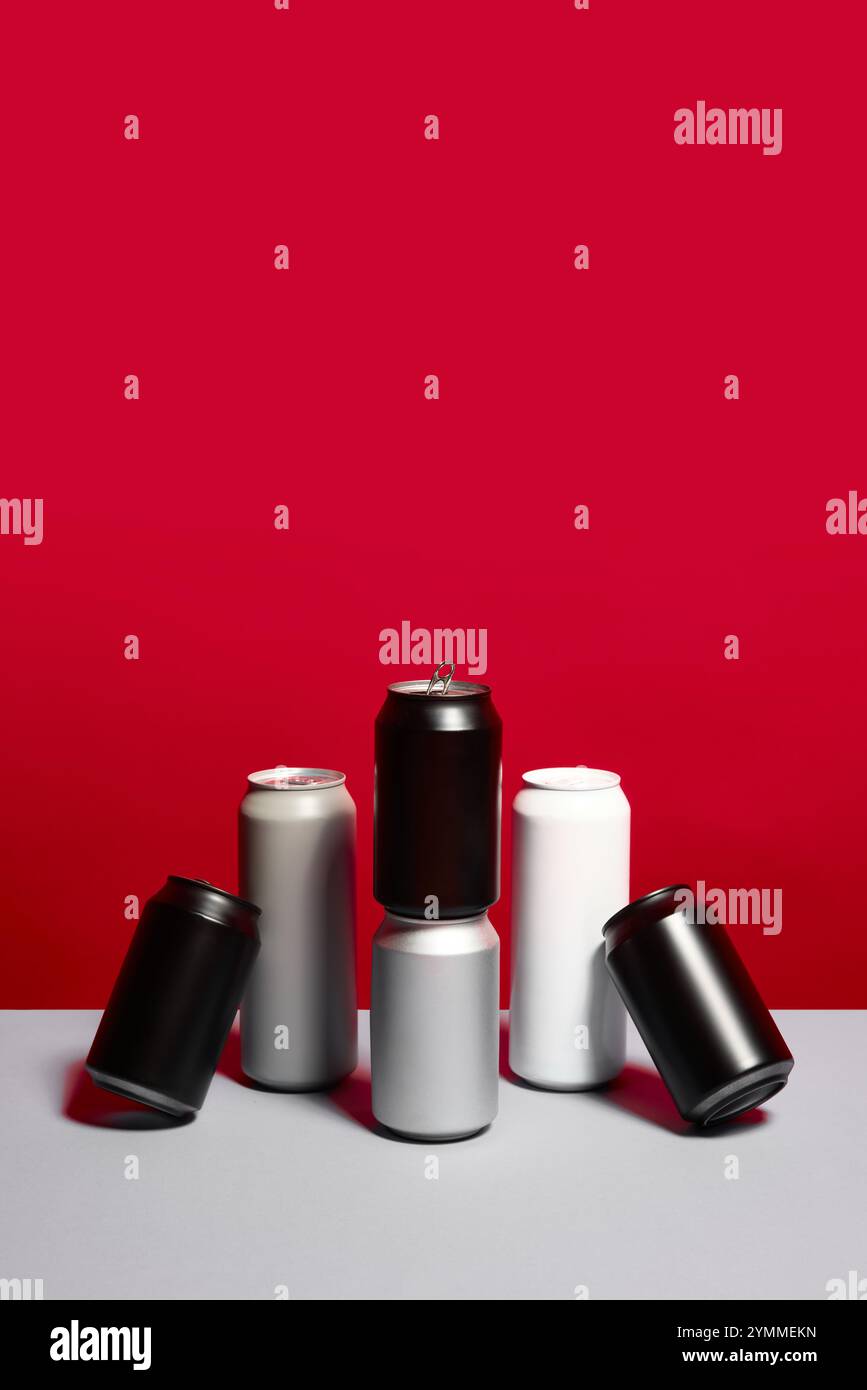 Five aluminum beverage cans in different colors, and sizes, arranged in ...