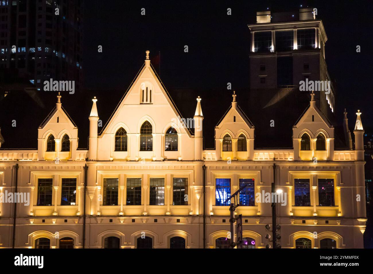 Illuminated historic buildings at the Bund street in Shanghai, China ...
