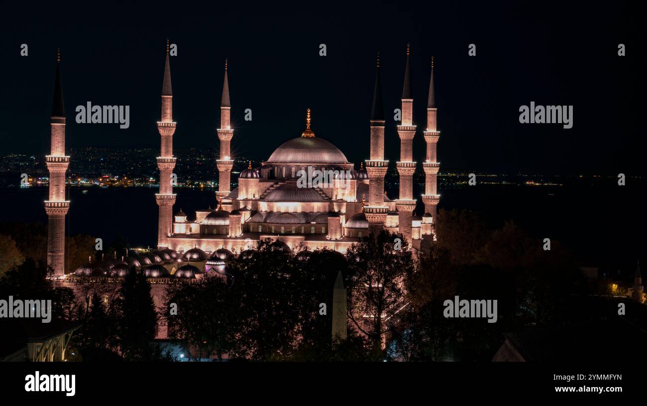 Illuminated sultan ahmed mosque with six minarets standing majestically ...