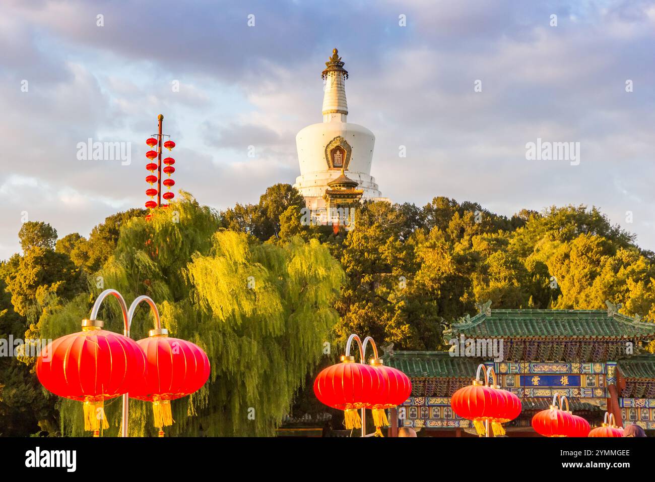 Traditional red lanterns in front of the white Bai Ta tower in Beijing ...