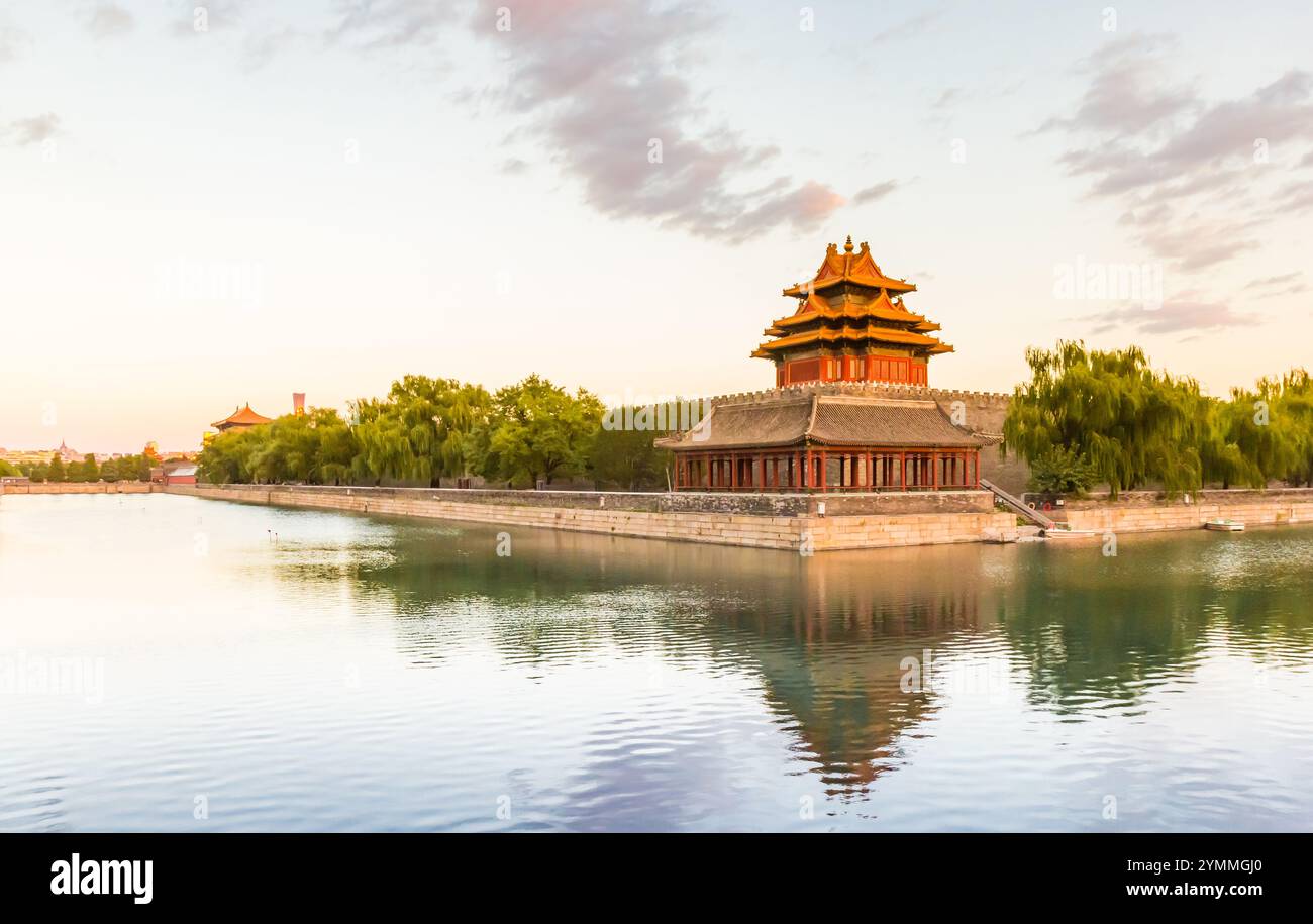 Corner tower reflected in the moat of the Forbidden City in Beijing ...
