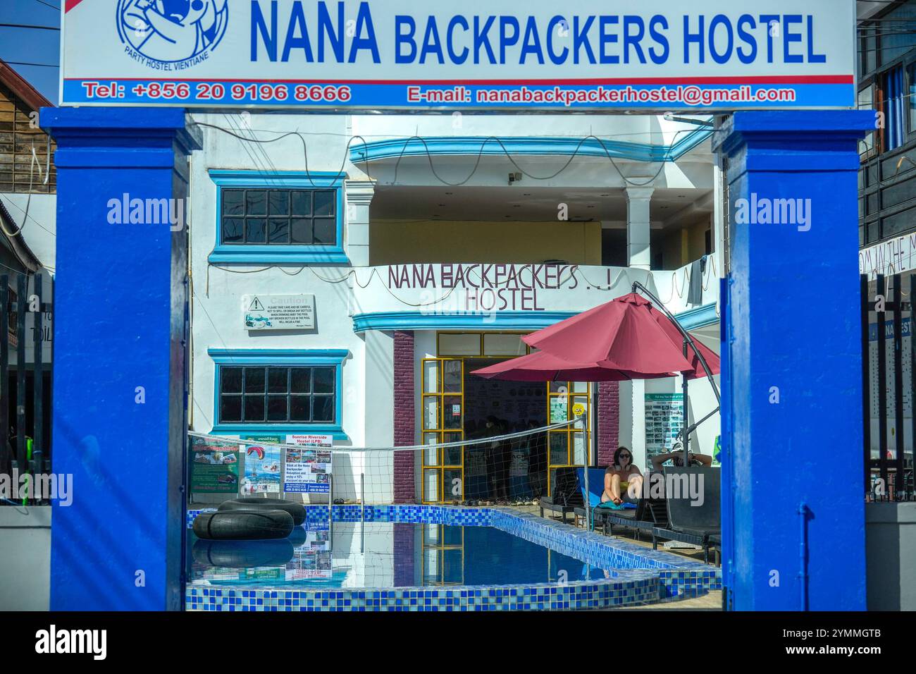 A foreign tourist couple rest near a swimming pool at Nana Backpackers ...