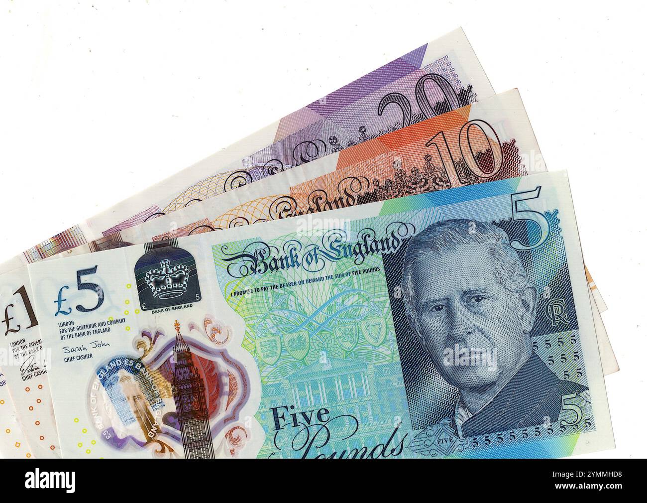 A King Charles III £5 banknote from the United Kingdom in a fan of ...