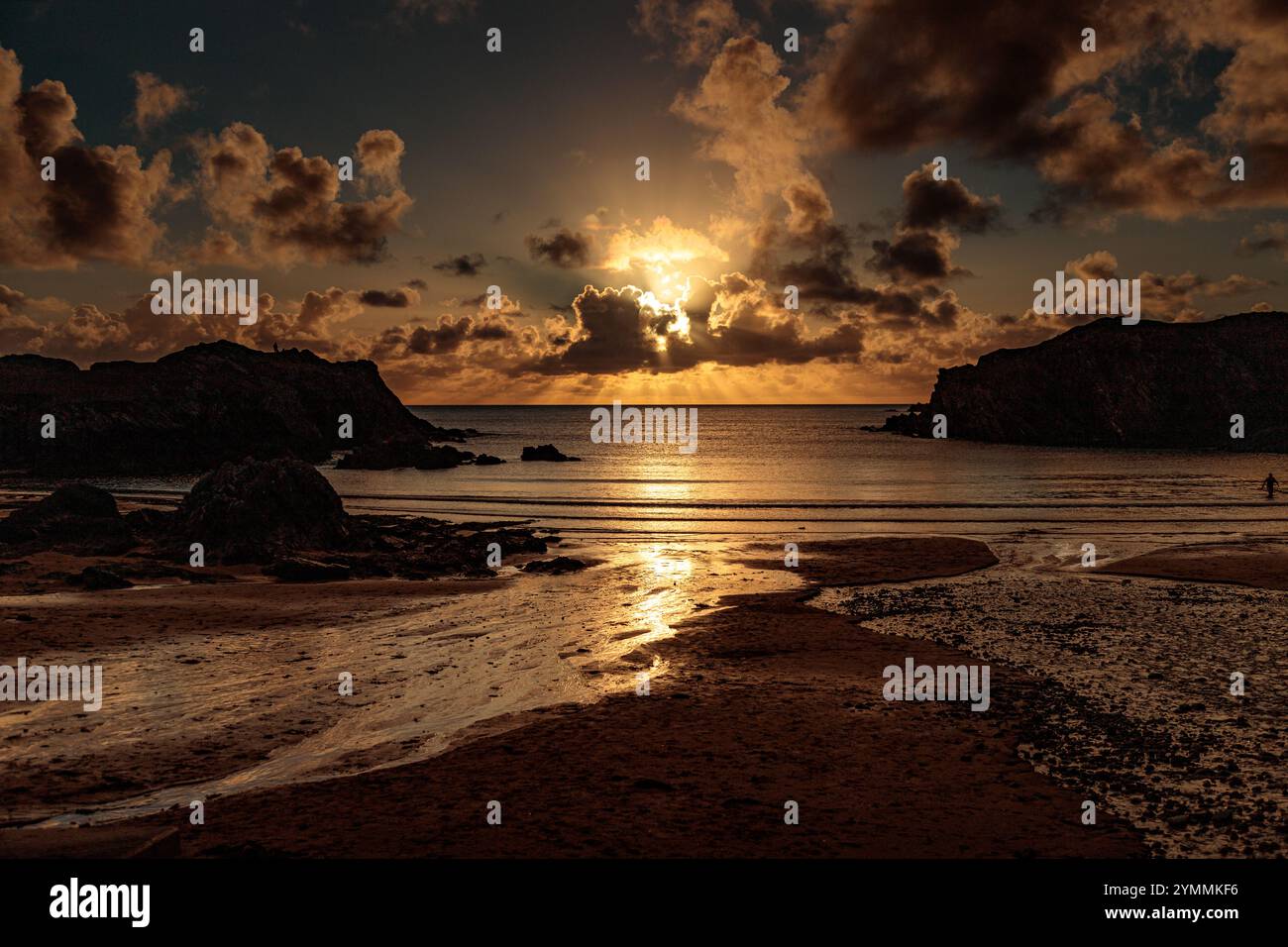 Sunbeams at sunset over Porth Dafach on the Isle of Anglesey, North ...