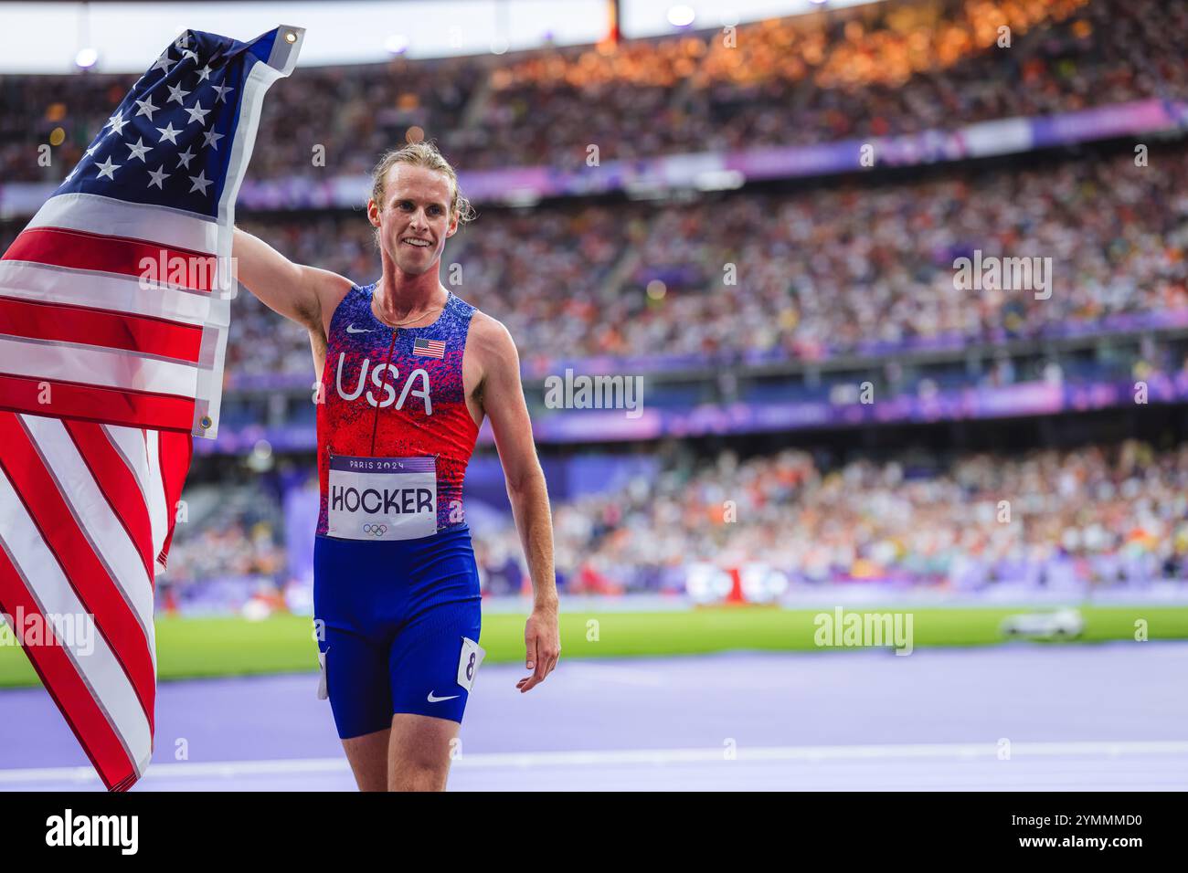 Cole Hocker celebrating her medal with her country's flag at the Paris ...