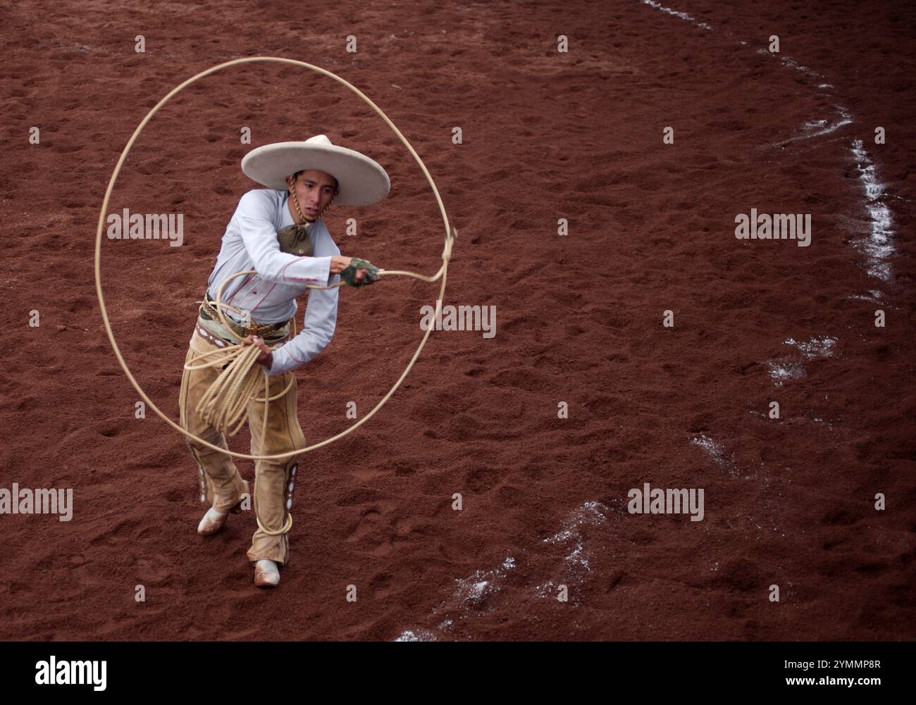 A Mexican Charro uses a lasso as he competes in a Charreria, or rodeo ...