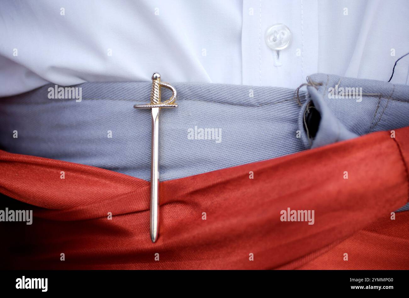 A sword pin decorates the clothes of an apprentice bullfighter before ...