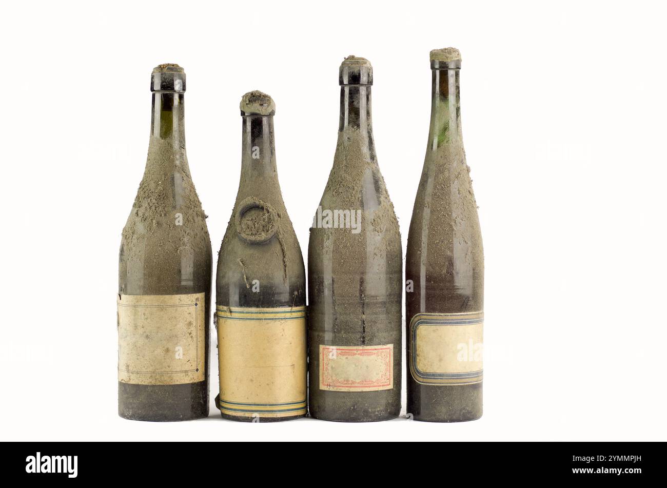 four dusty bottles of old wine lined on white background Stock Photo ...