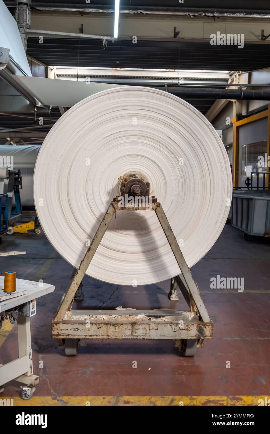 A roll of white fabric in a textile factory in close up view Stock ...