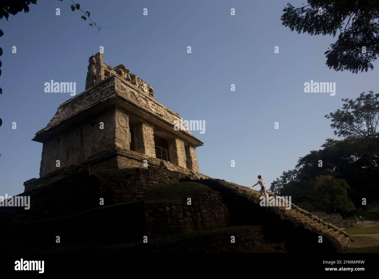 A tourist visits the Temple of the Sun at the ancient Mayan city of ...