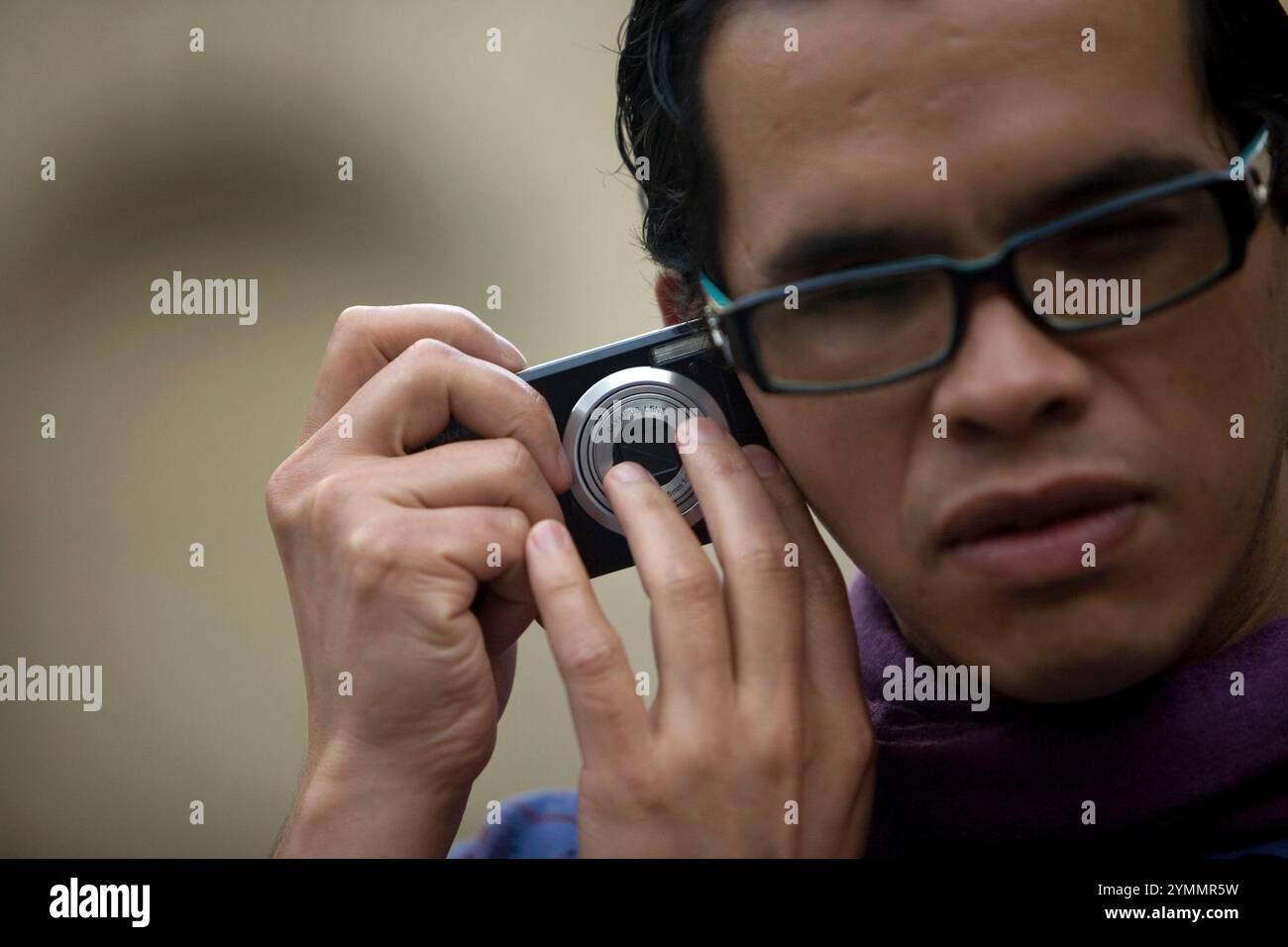 A visually impaired student puts his camera to his ear during a ...