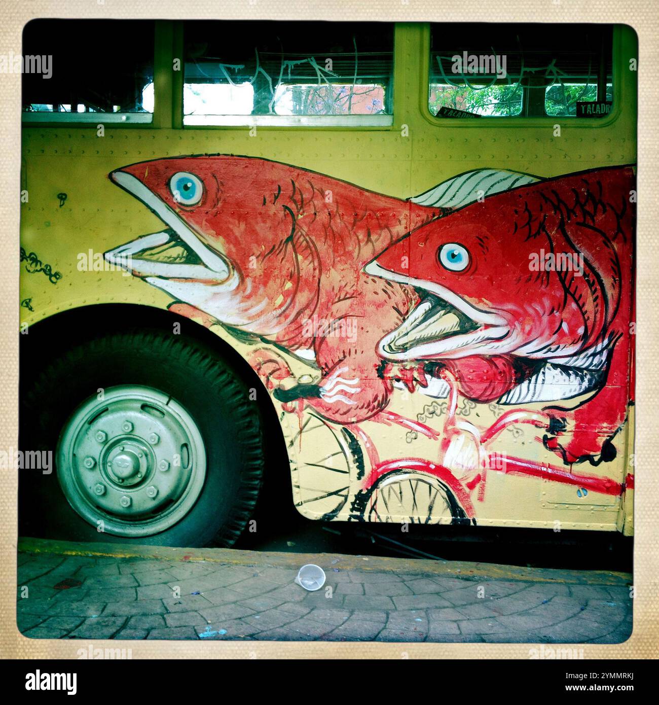 A painting of fish riding bicycles decorate a bus in Parque Mexico ...