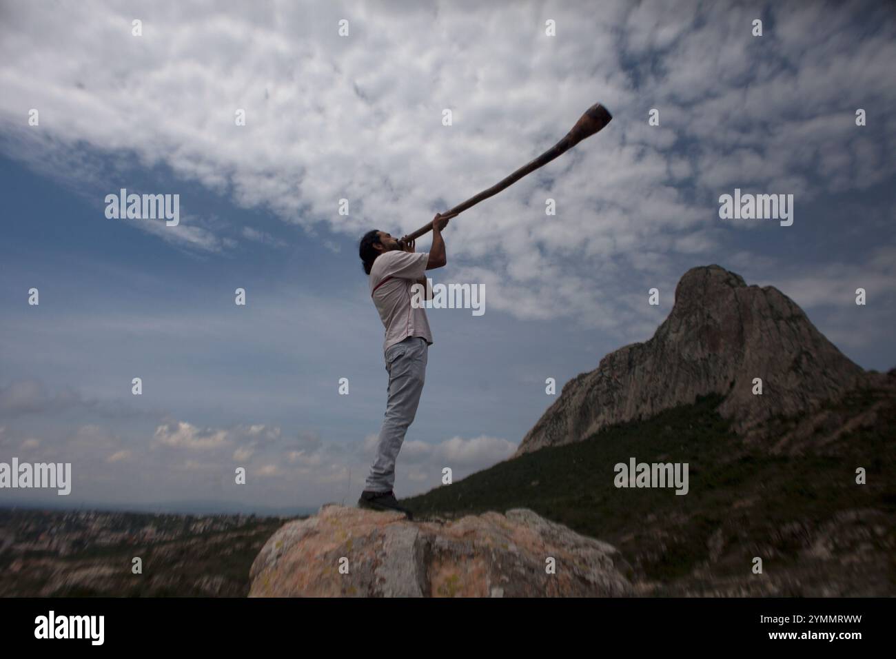 Musicison plays a Mayan trumpet in front of the PeÃƒÂ±a de Bernal ...