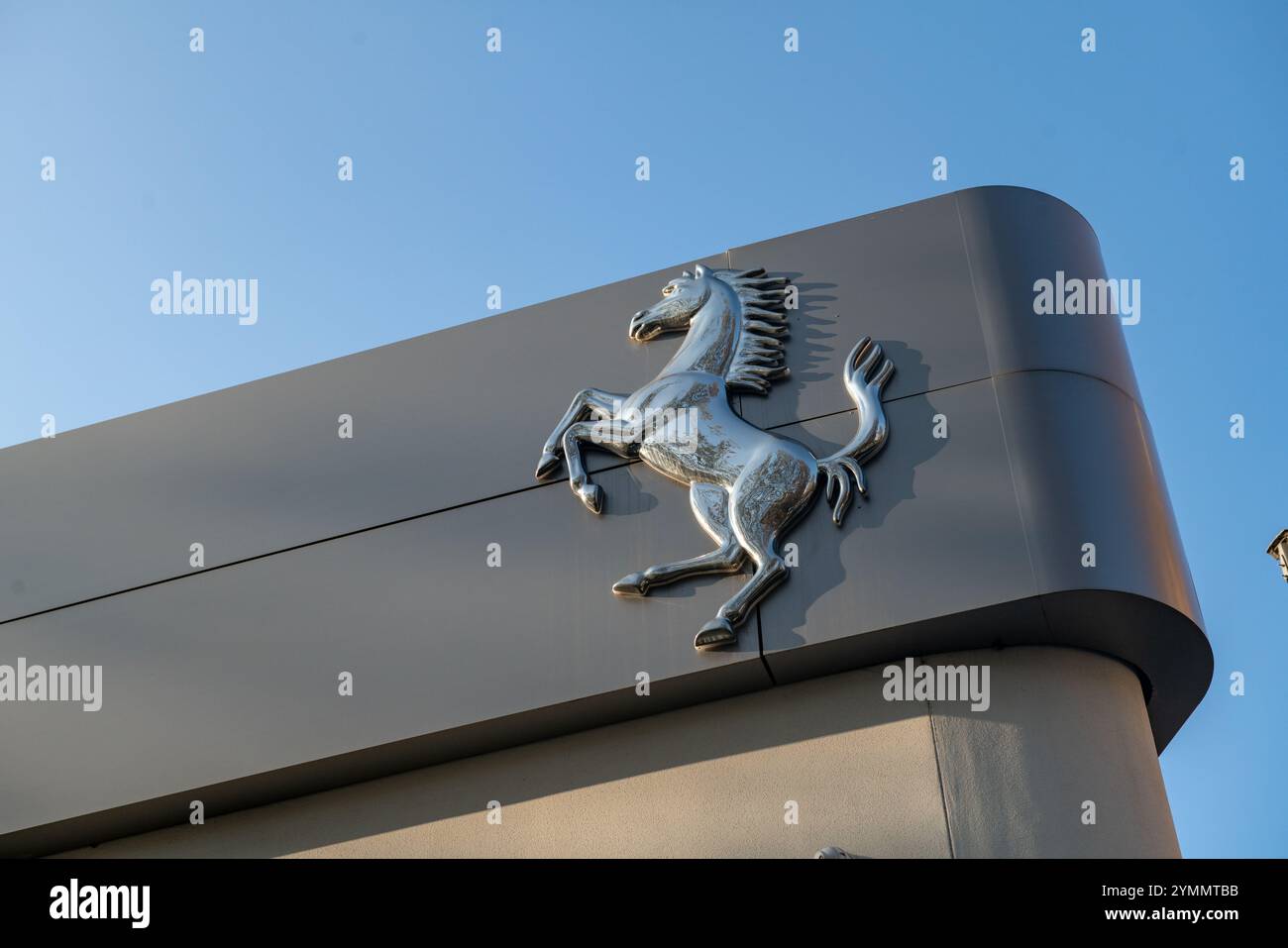 Ferrari is a symbol of prestige and power, a shop with the sign of the ...