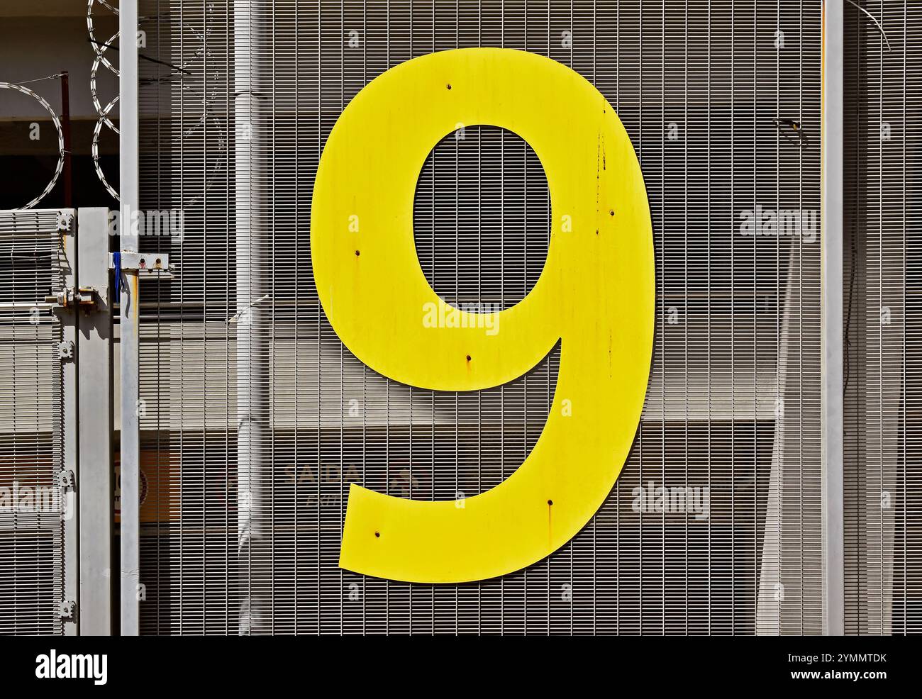 Number nine in metal on metallic grid Stock Photo - Alamy