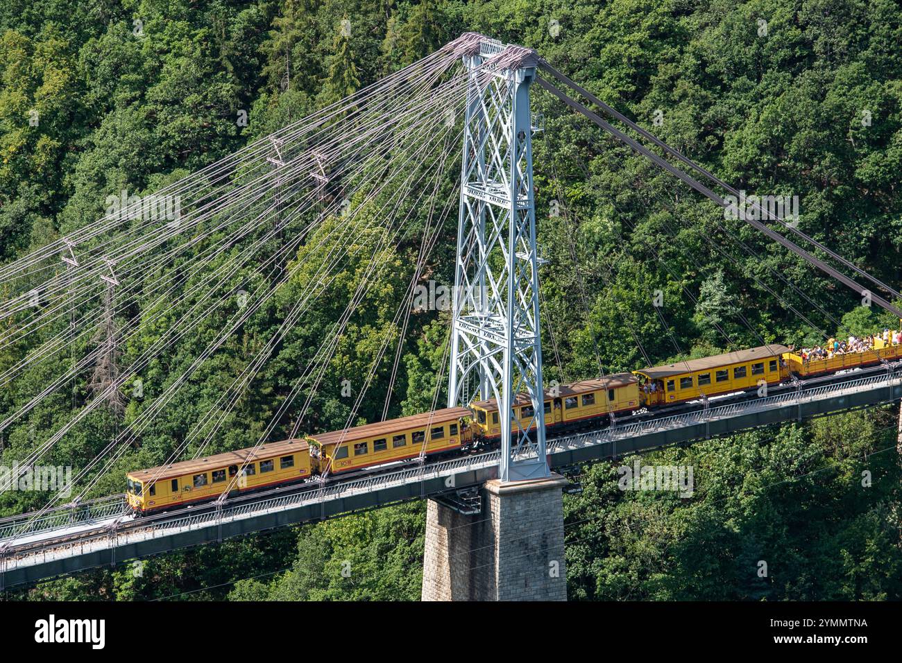 Planès (south of France): yellow train on the suspension bridge “pont ...
