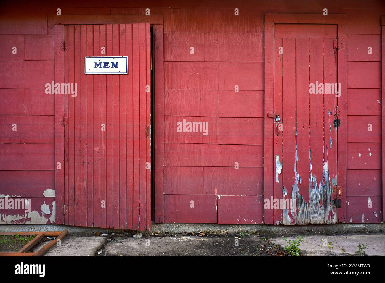 This rustic restroom facility features two wooden doors, one labeled ...