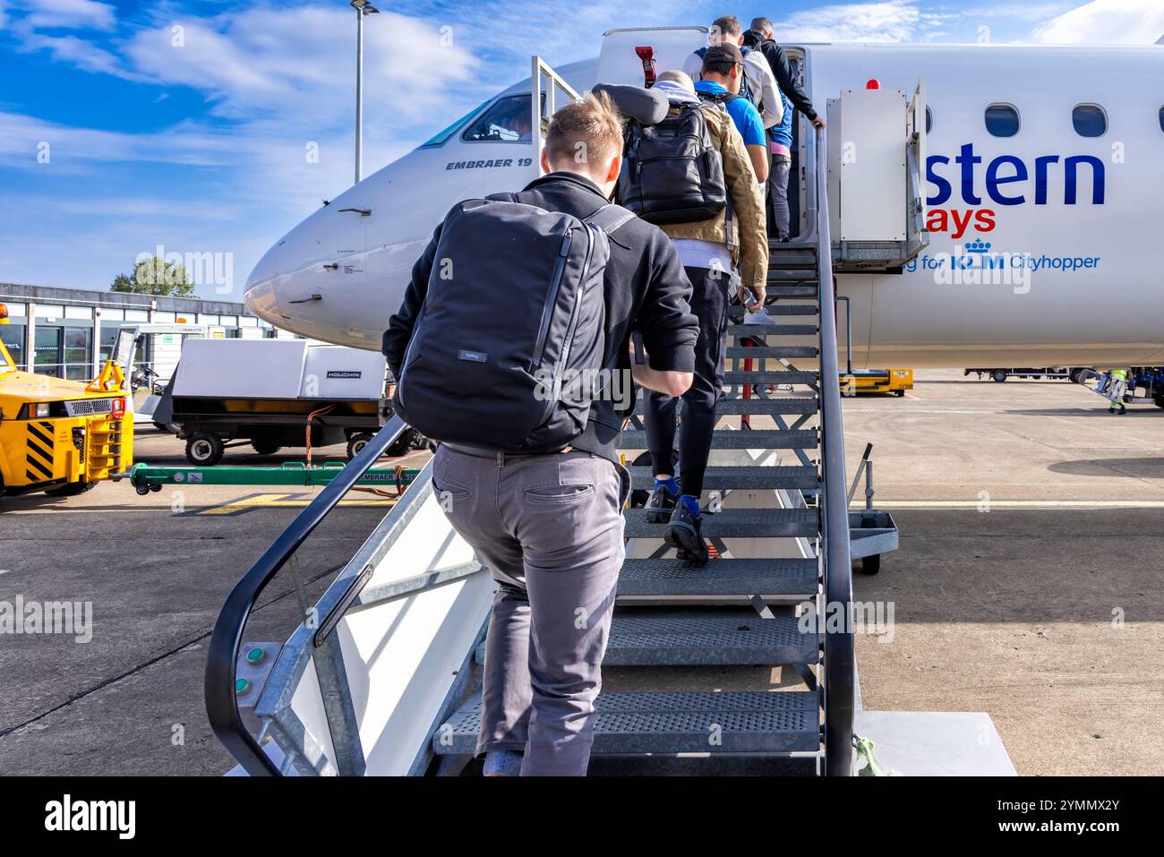 Passengers with hand luggage boarding KLM Eastern flight from Teesside International Airport ...
