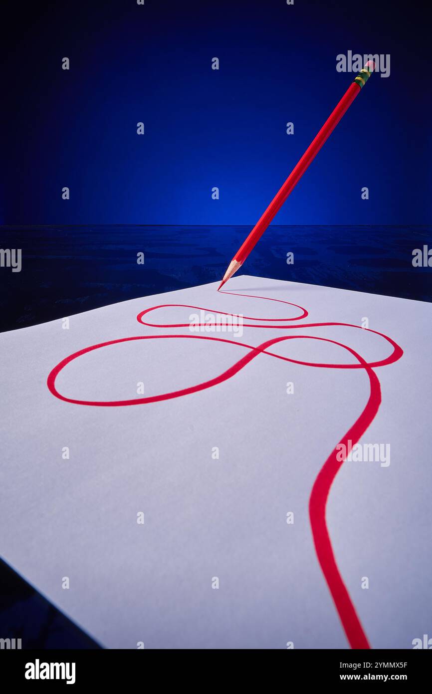 Red pencil drawing a swirling line Stock Photo - Alamy