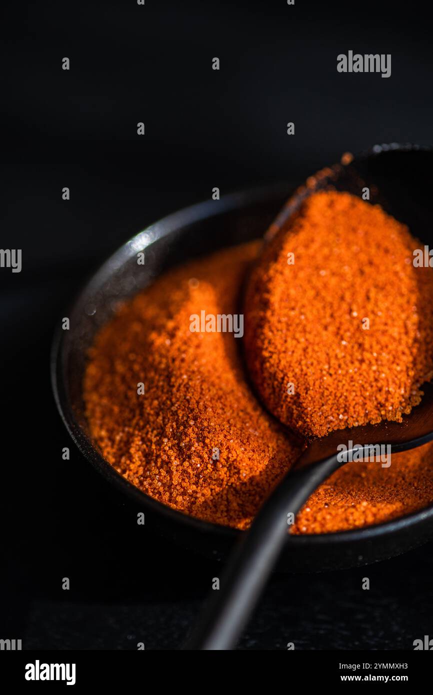 Spicy salt made up of powdered chilli pepper and sea salt in the spoon ...