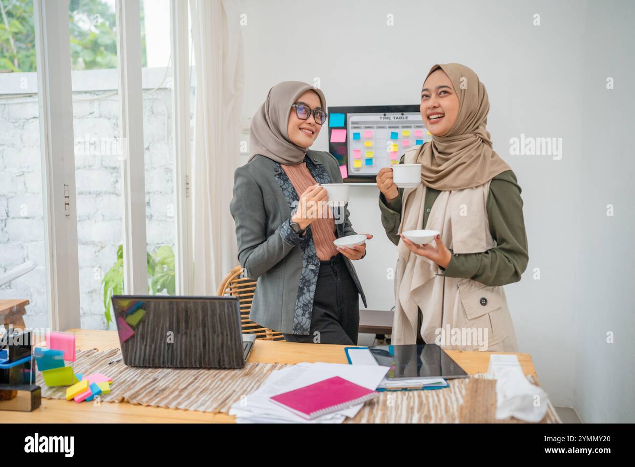 Two Women Engaging in a Delightful Coffee Break Inside a Modern Office Environment Stock Photo ...