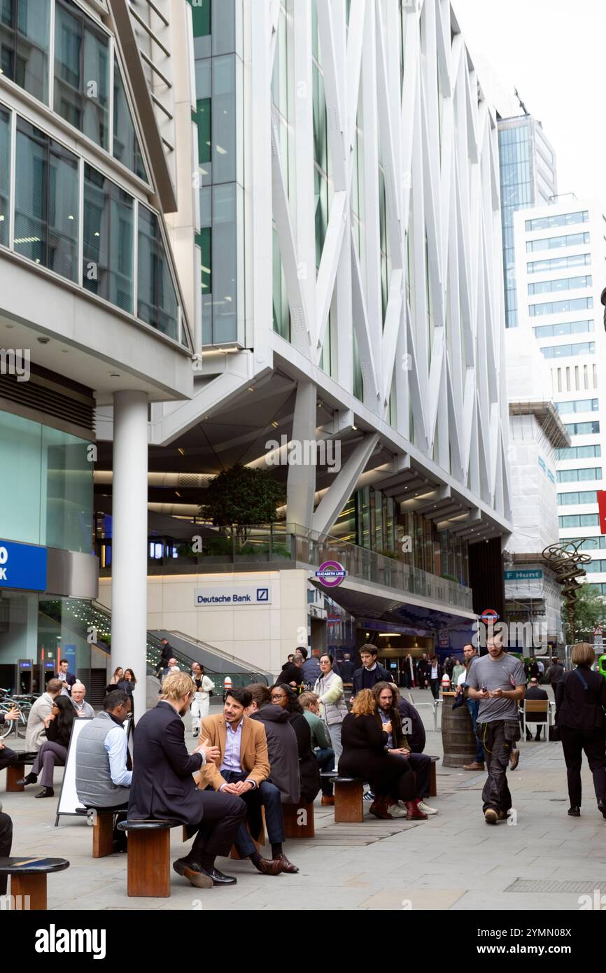 People office workers sitting on benches talking outside Deutsche Bank ...
