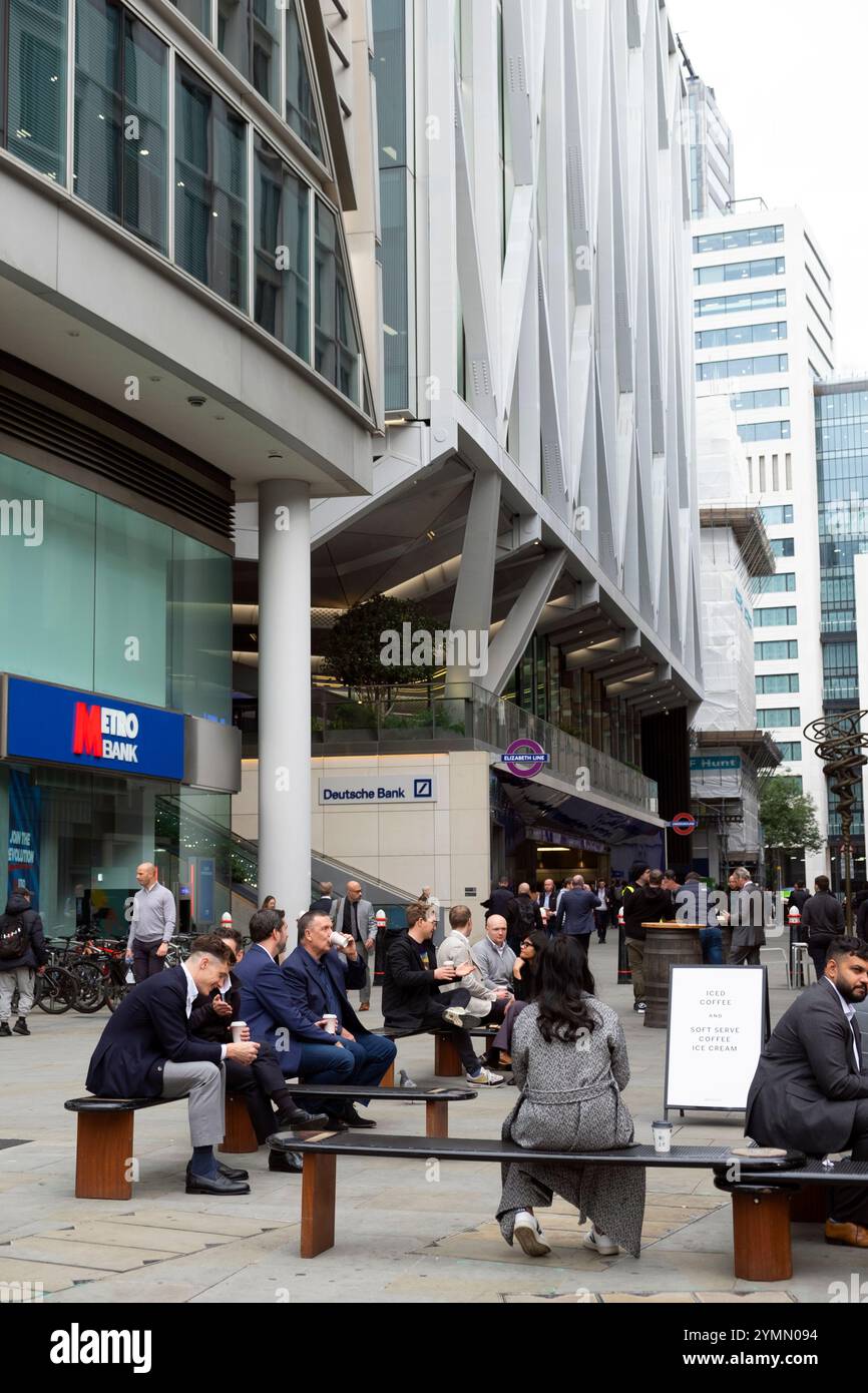 People office workers sitting on benches talking outside Deutsche Bank ...