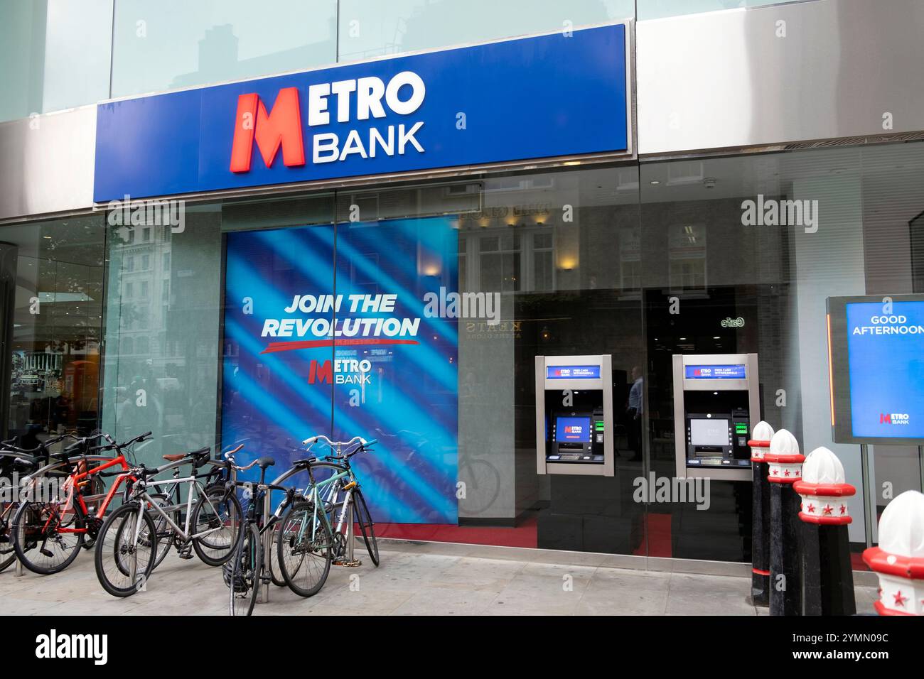 Exterior view of Metro Bank building ATM and sign bikes parked outside ...