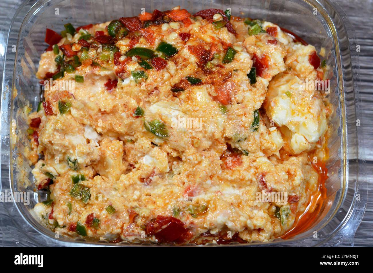 Egyptian barrel Baramily cheese with slices of red and green peppers ...