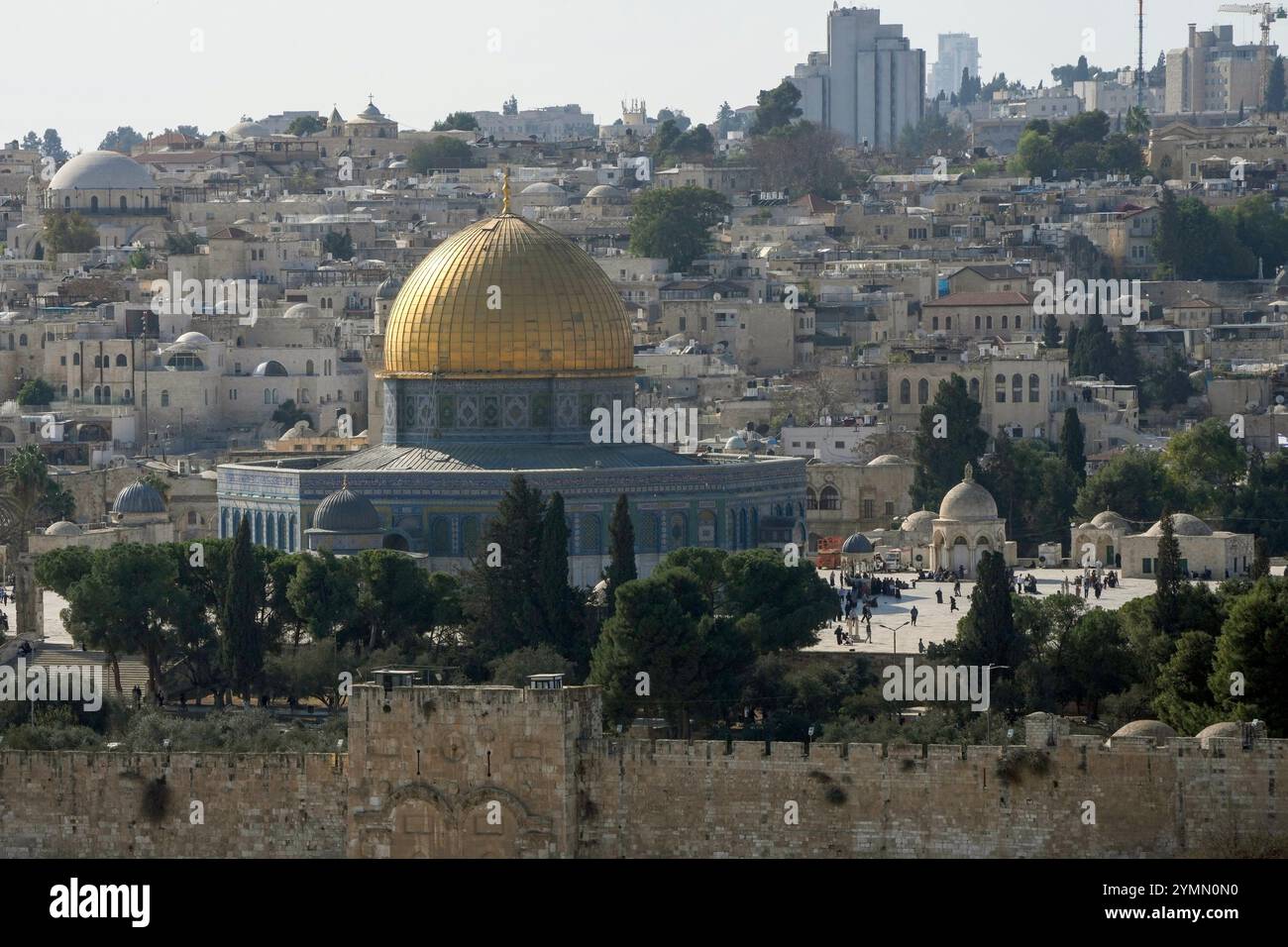 Muslims walk next to the Dome of Rock Mosque at the Al-Aqsa Mosque ...