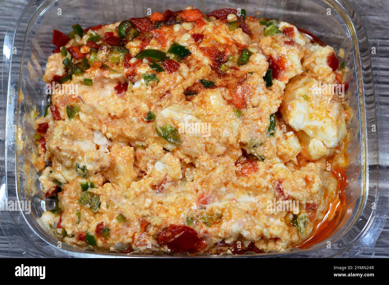 Egyptian barrel Baramily cheese with slices of red and green peppers ...