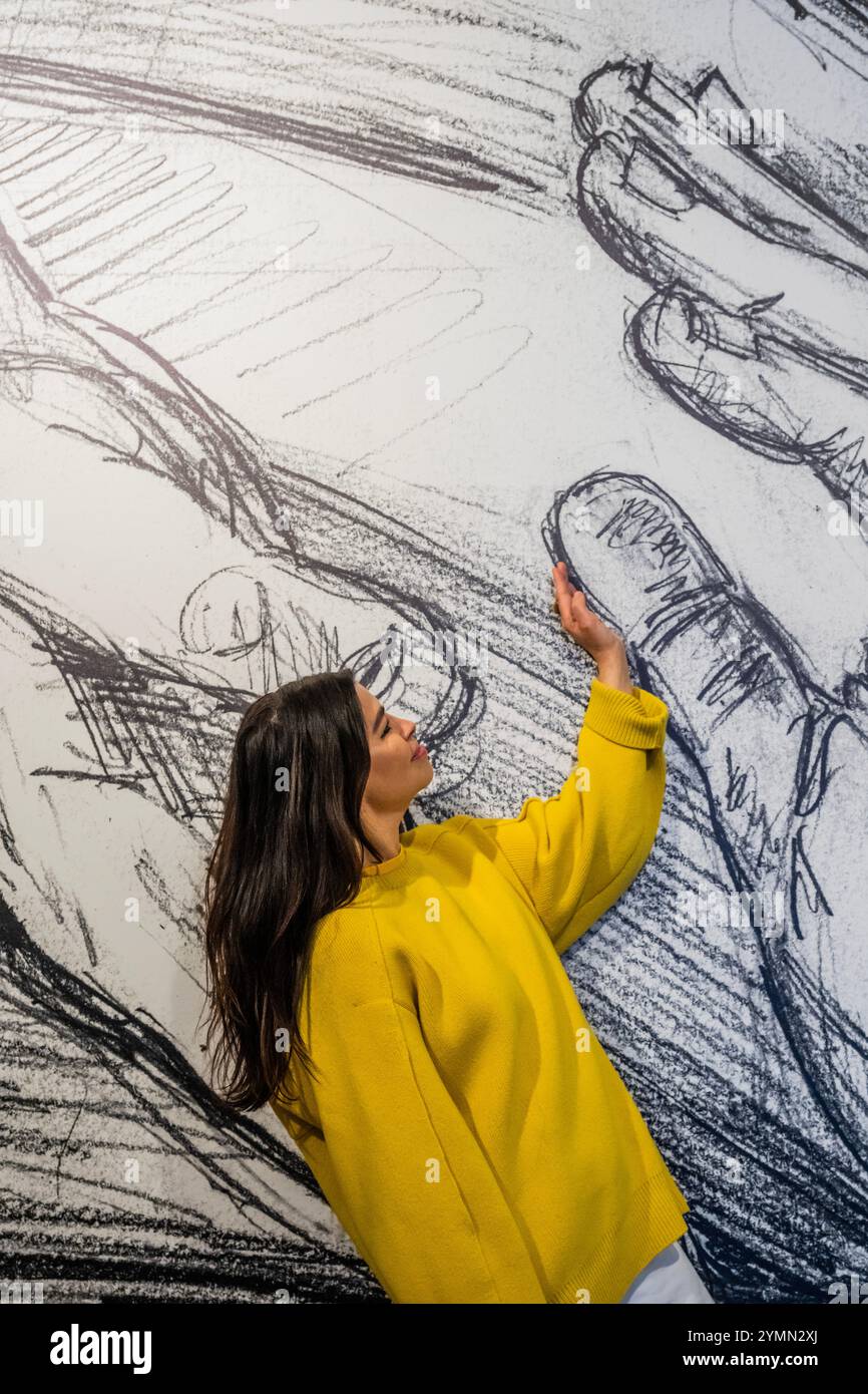 London, UK. 22 Nov 2024. The artist with a giant installation mural ...