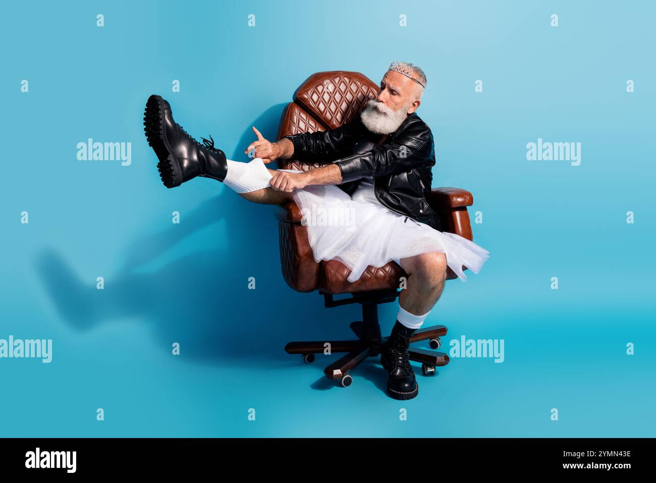 Photo of aged man sit chair wear skirt boots blazer adjust white sock ...