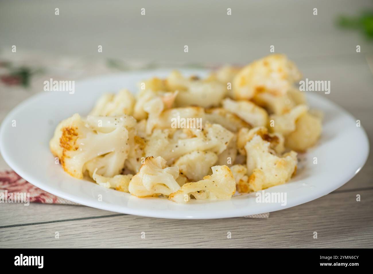 Diet boiled cauliflower fried in oil with spices Stock Photo - Alamy