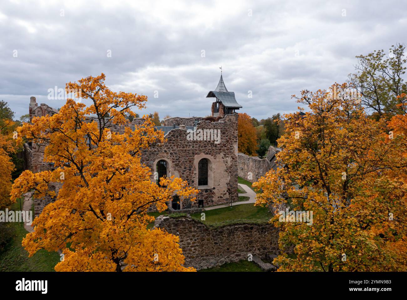 Autumn leaves surround historic ruins during overcast weather in a ...