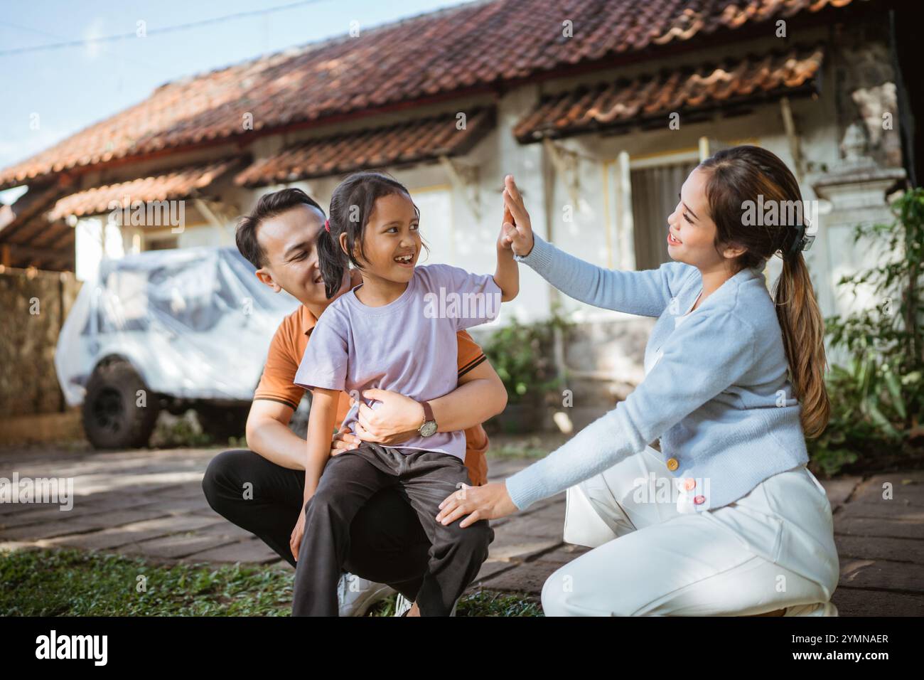 young girl high five with her mother Stock Photo - Alamy