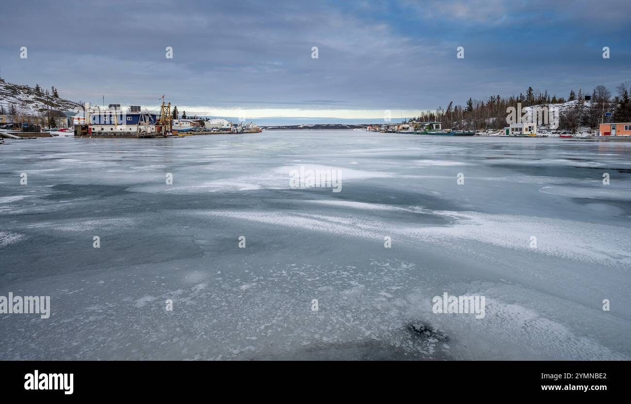Barges and houseboats on frozen Great Slave Lake at Yellowknife ...