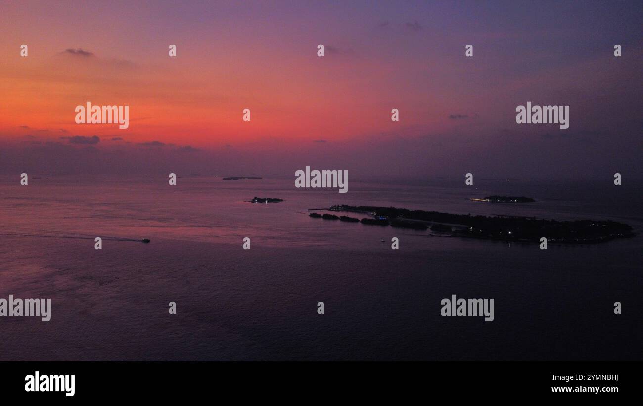 Pink sunset over Sheraton Maldives Full Moon Resort & Spa Stock Photo ...