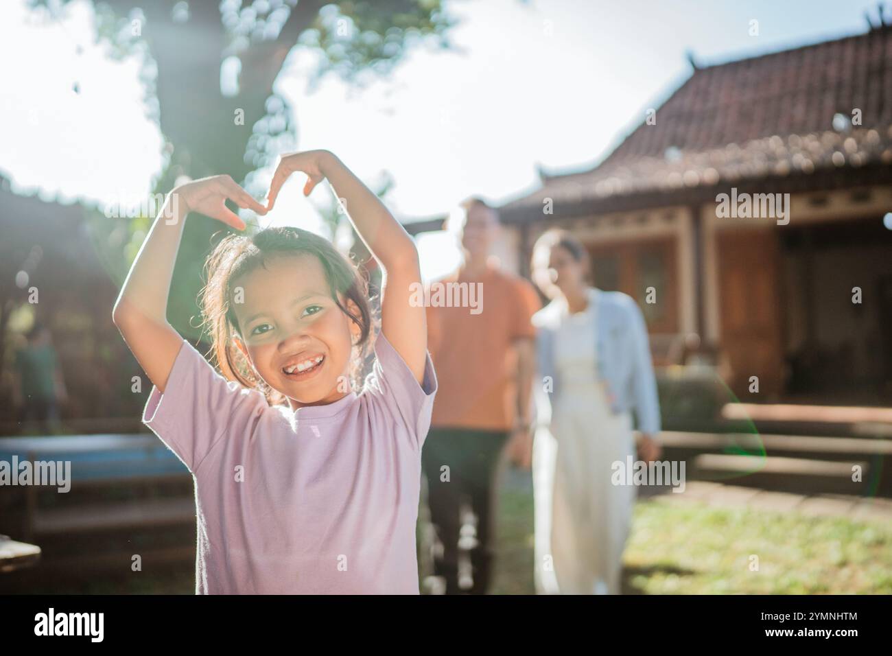 asian kid girl posing with heart sign Stock Photo - Alamy