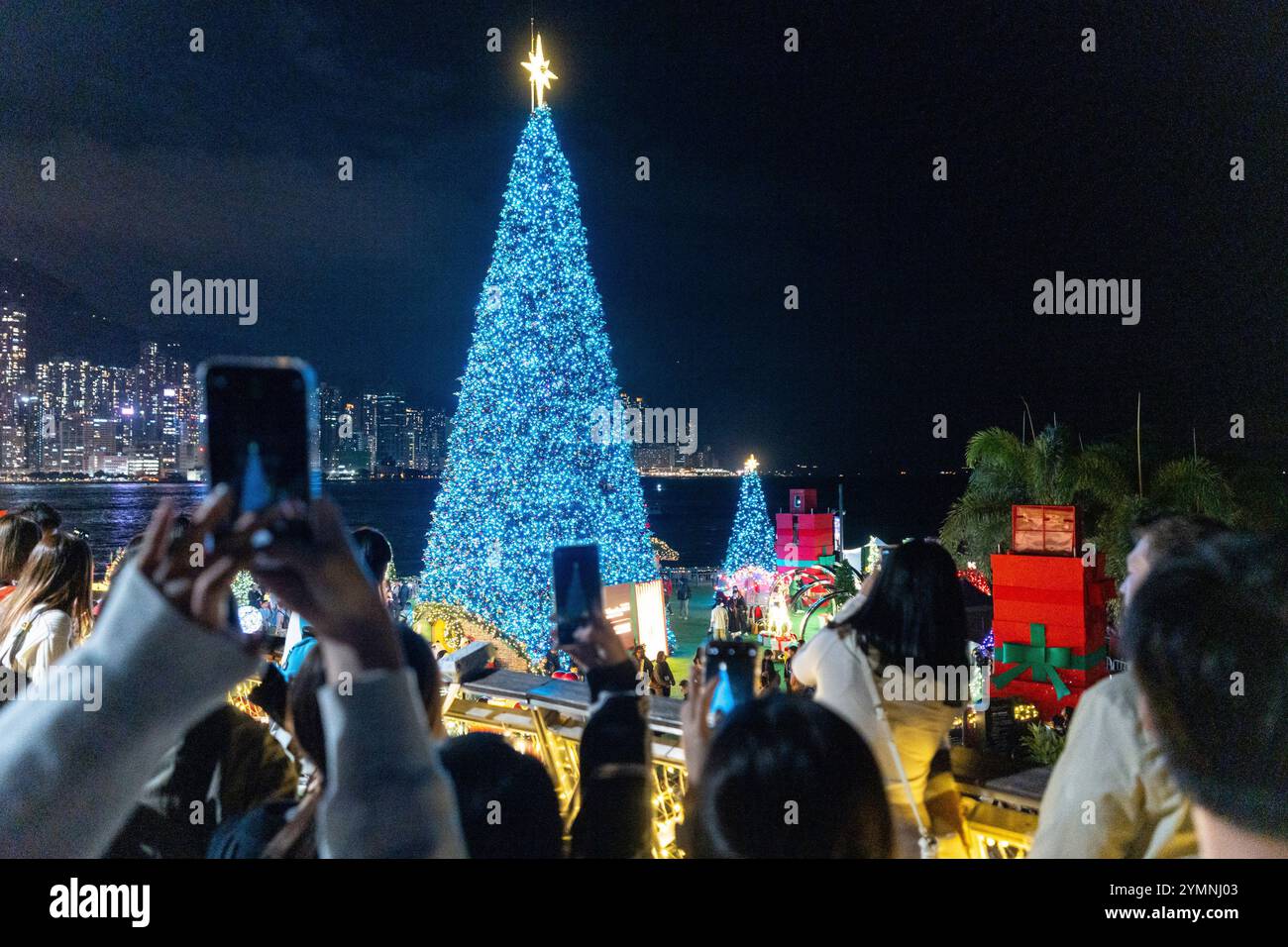 Christmas trees stand beside the waterfront of Victoria Harbour in West ...