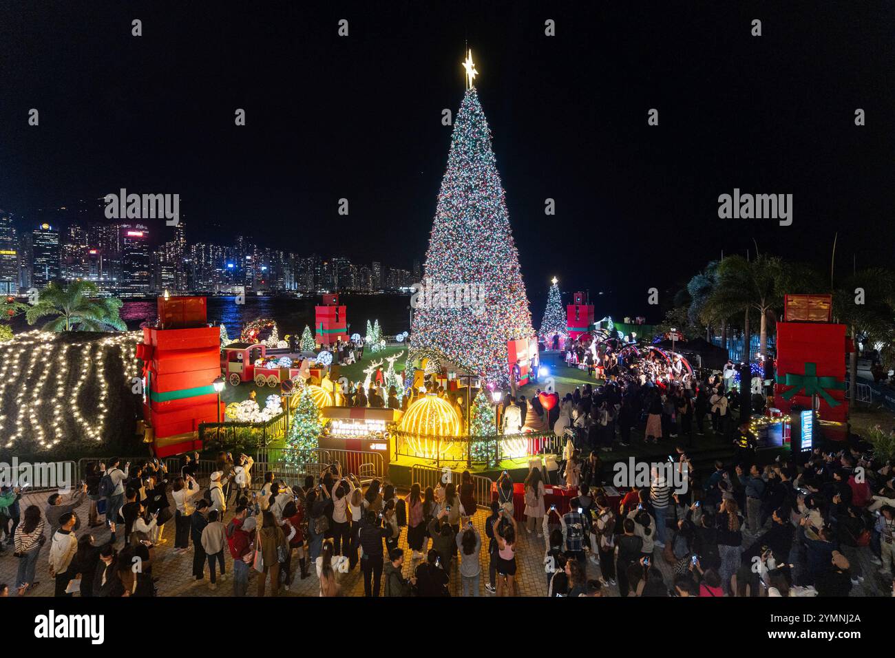 Christmas trees stand beside the waterfront of Victoria Harbour in West ...